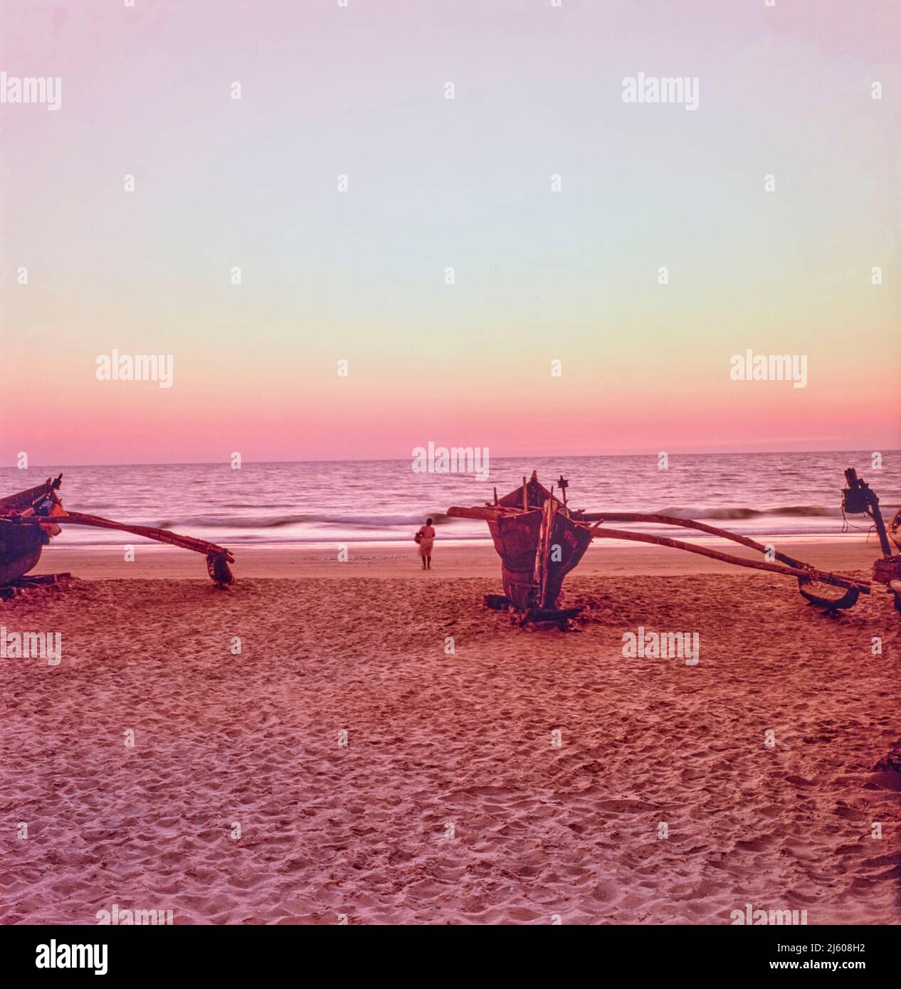 Outrigger fishing boats in Goa, on the beach at sunset Stock Photo - Alamy
