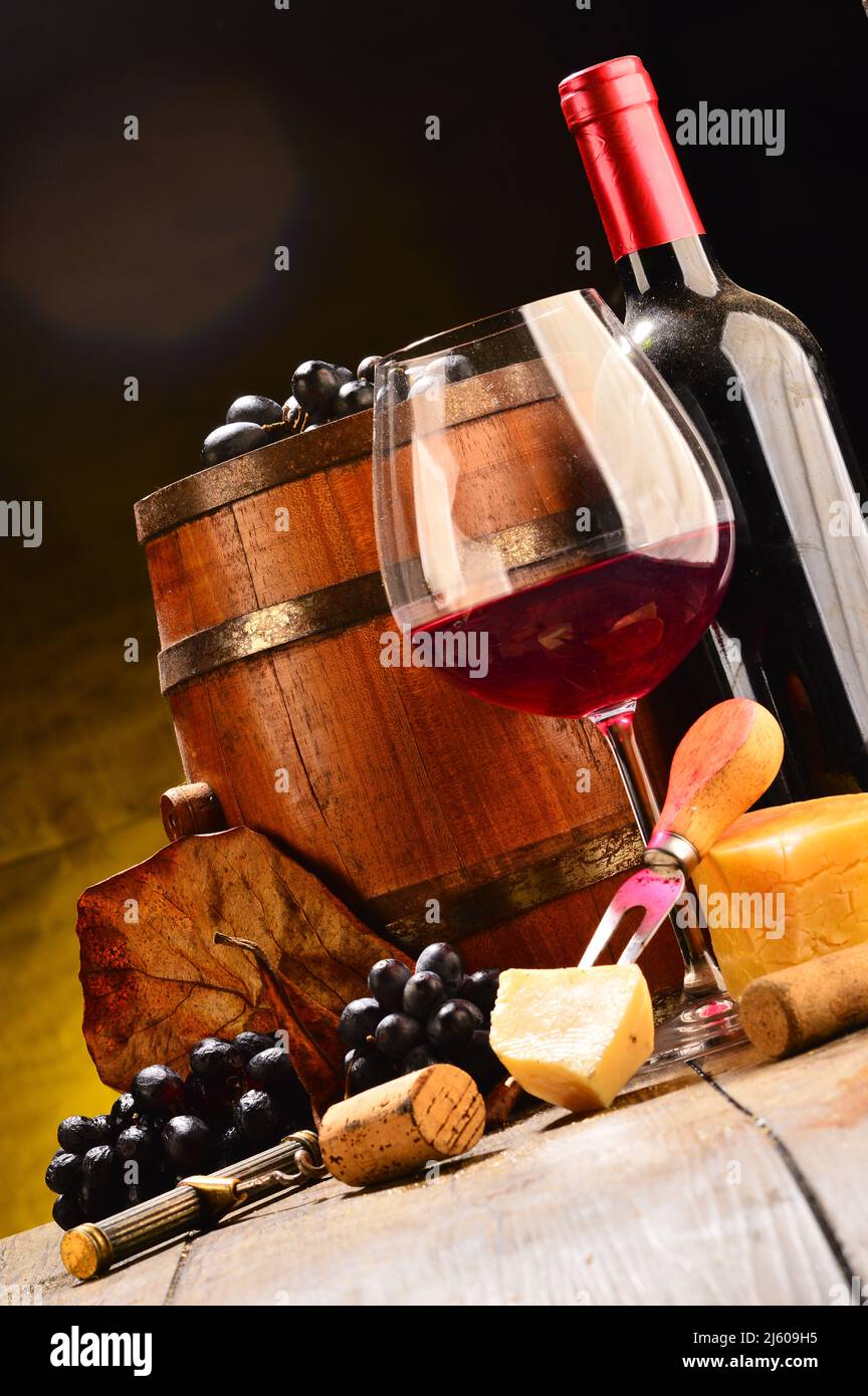 Still life with wine barrel, bottle,glass and grapes.yelow background ...