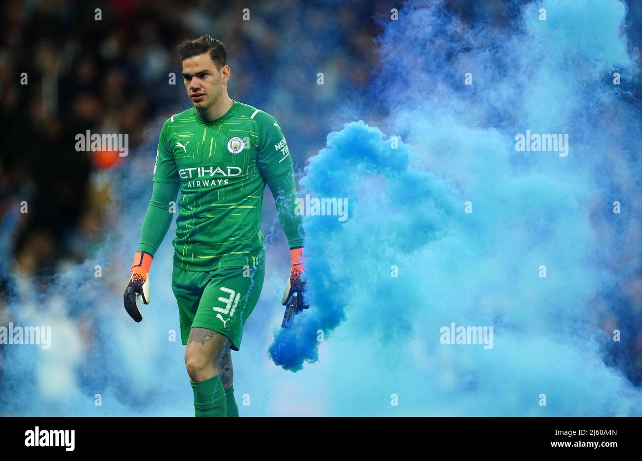 Manchester City goalkeeper Ederson clears a flare of the pitch after ...