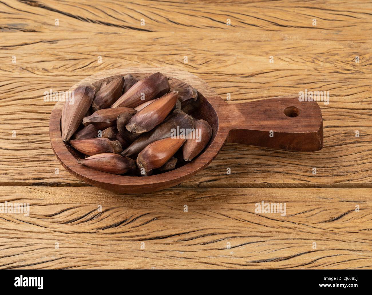Pine tree seed, typical brazilian june festival food over wooden table ...