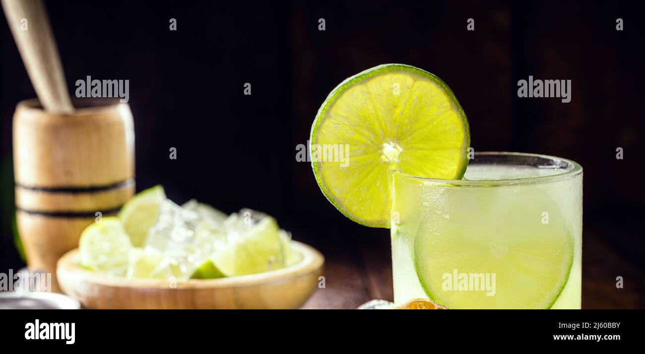glass with typical Brazilian drink called "caipirinha", made with lemon ...