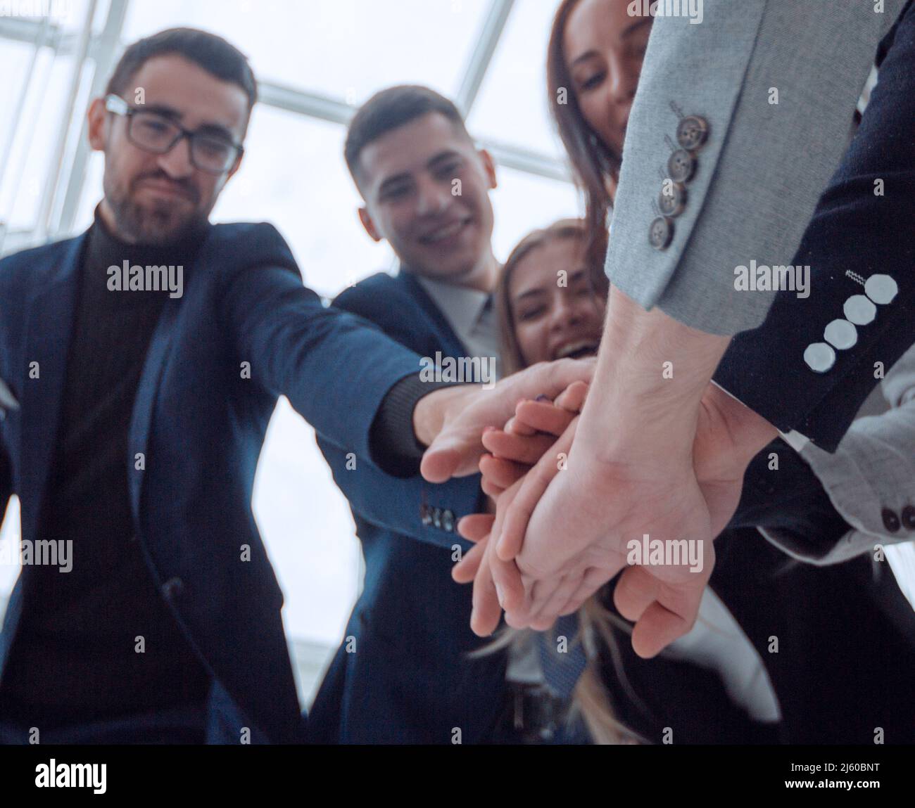 group of young employees showing their unity Stock Photo - Alamy