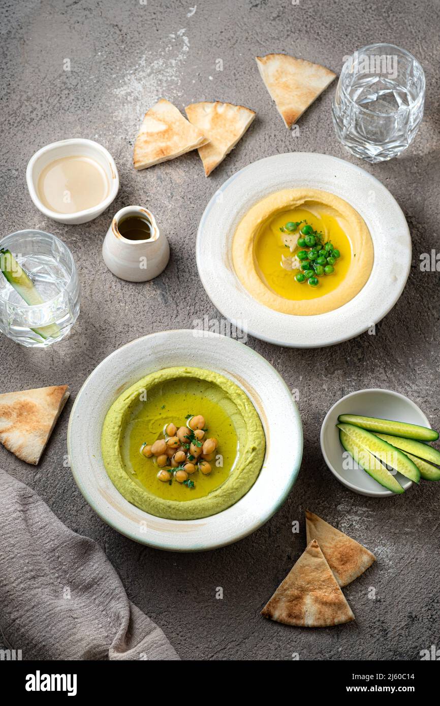 Snow peas Hummus and chick peas hummus, with water and fresh vegetables ...