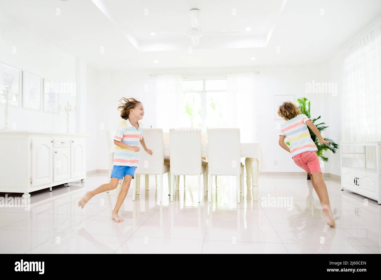 Kids play at home. Children jump, run and dance. Active boys playing ...