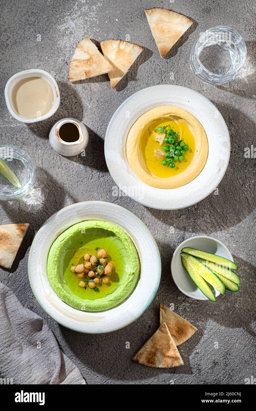 Delicious arabic hummus with fresh cucumber, top view Stock Photo - Alamy