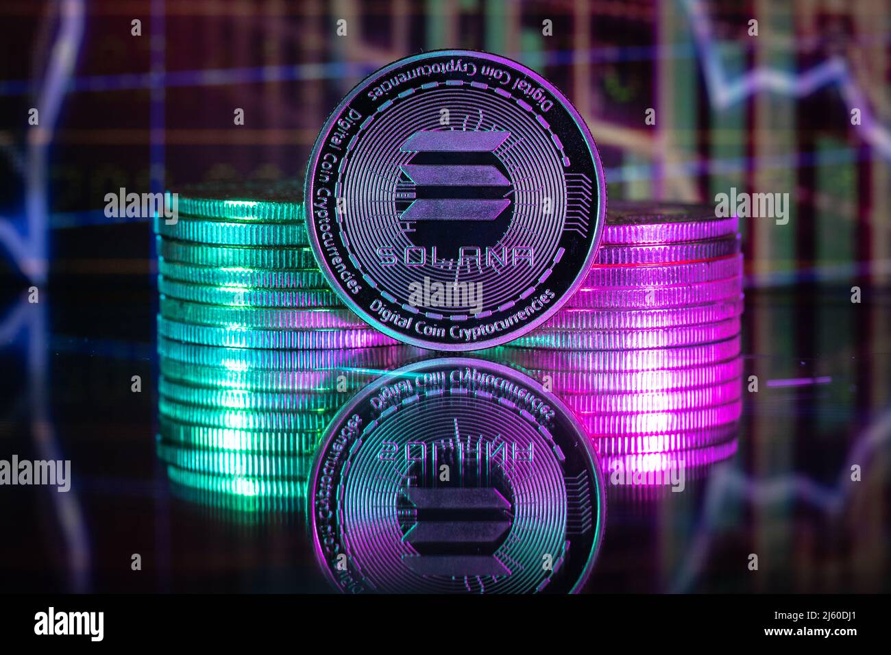 Solana SOL cryptocurrency physical coin and blurry price charts Stock ...
