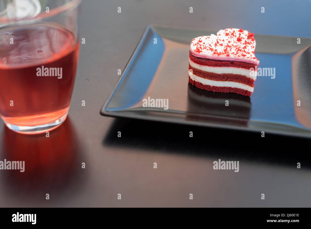 Red Velvet cake with tea and coffee in an urban coffee shop terrace ...