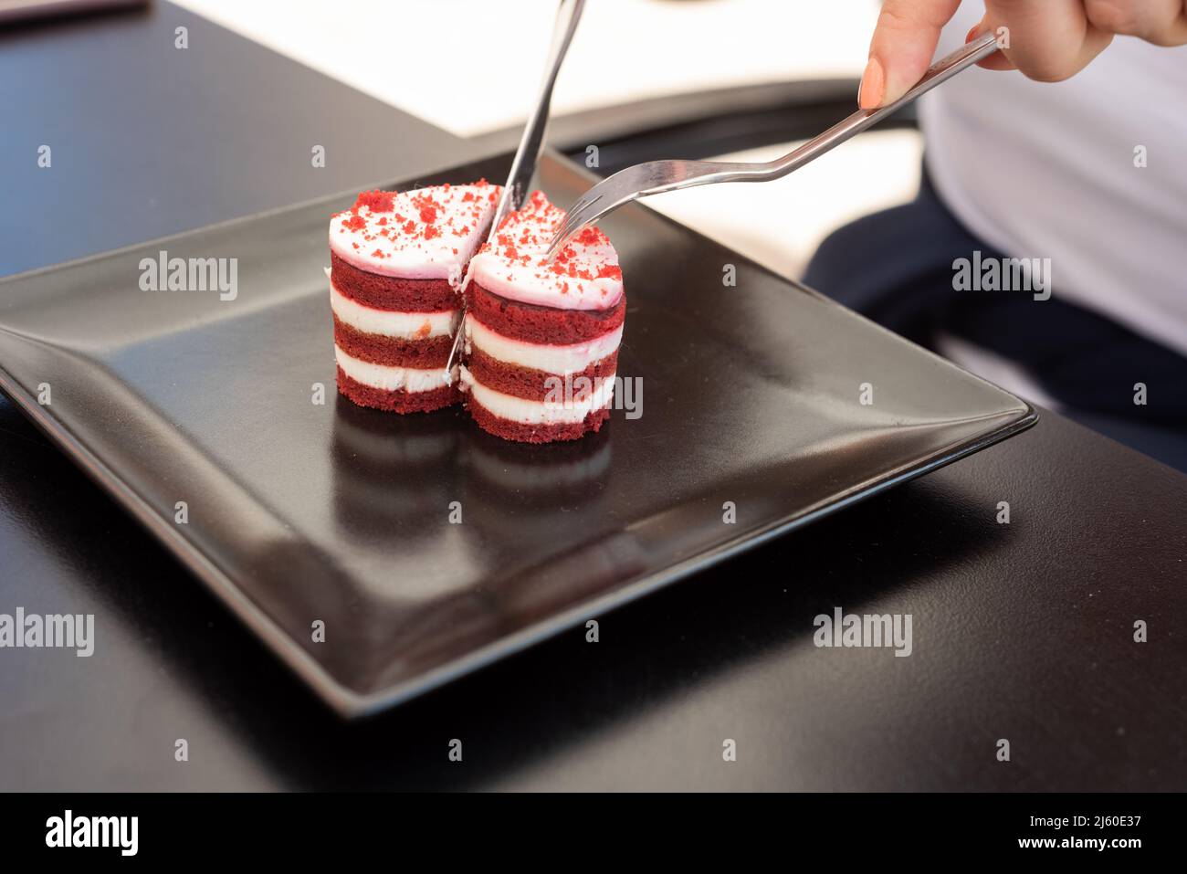 Red Velvet cake with tea and coffee in an urban coffee shop terrace ...