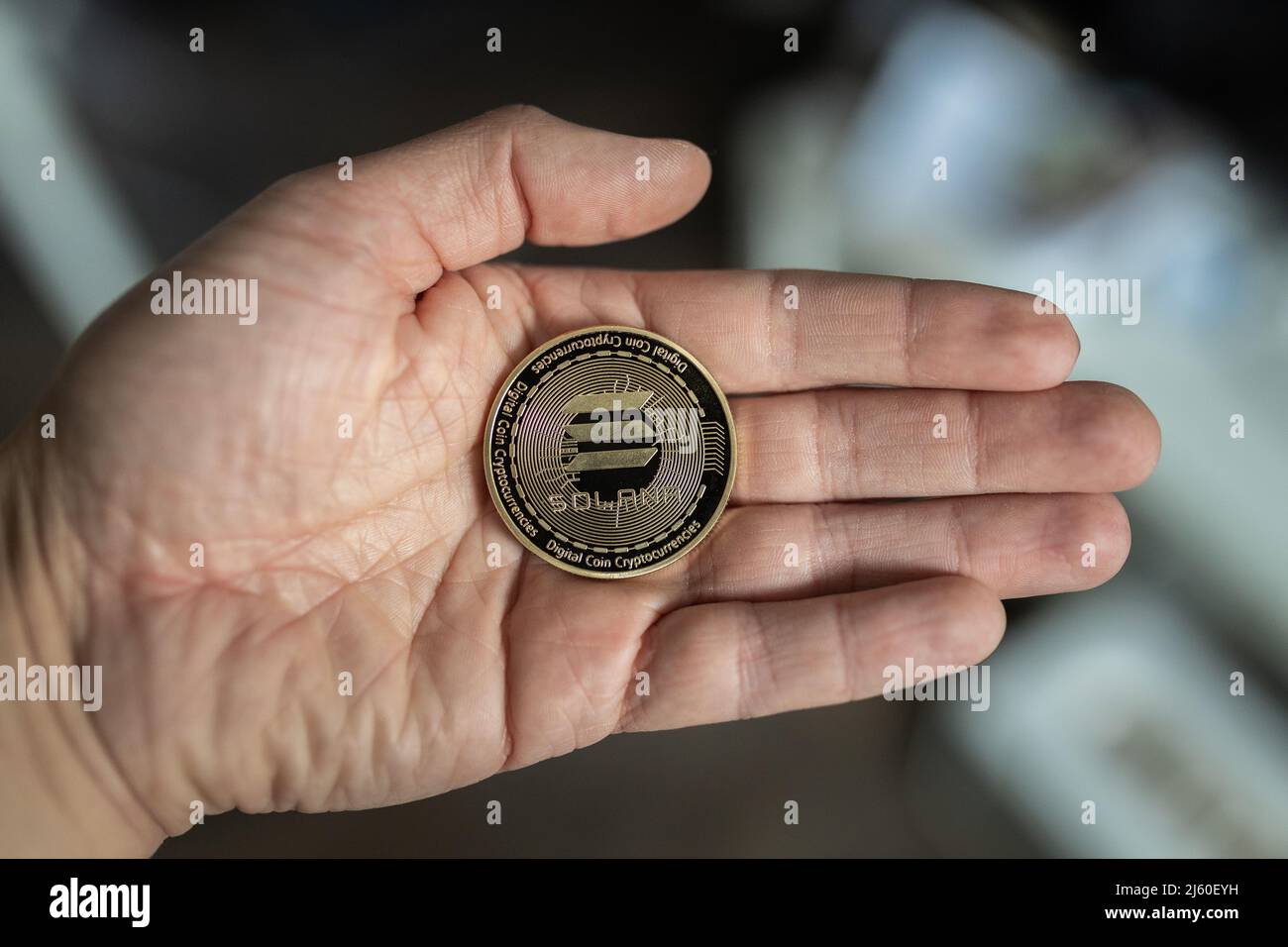 Solana SOL cryptocurrency physical coin held in a hand Stock Photo - Alamy