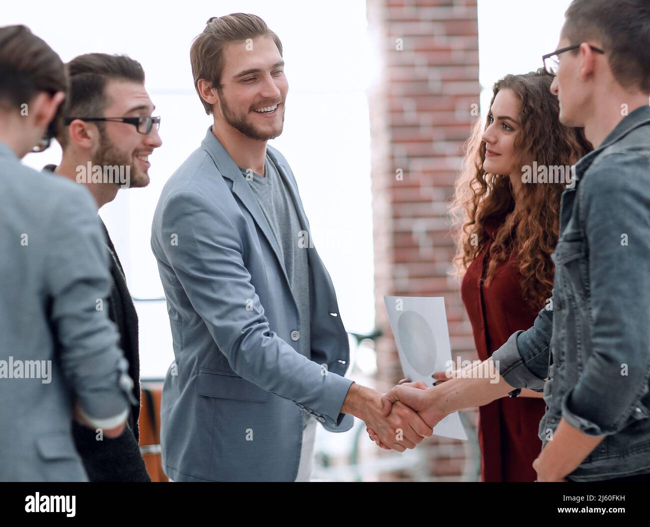 handshake partners in the creative office Stock Photo - Alamy