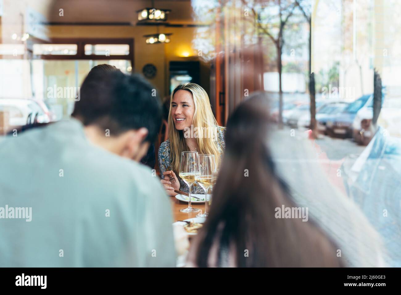 Caucasian woman seen through a glass window inside a restaurant Stock ...