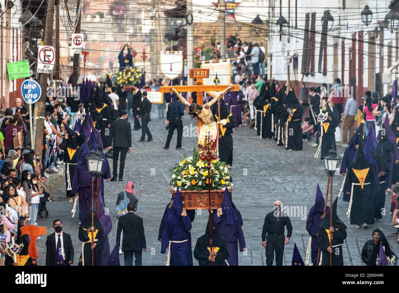 Roman Catholic hooded penitents wearing traditional capirotes, carry a ...