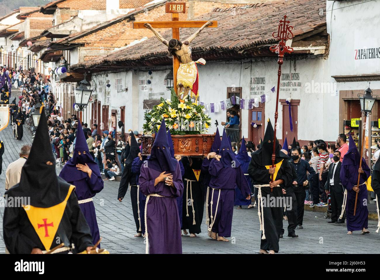 Roman Catholic hooded penitents wearing traditional capirotes, carry a ...