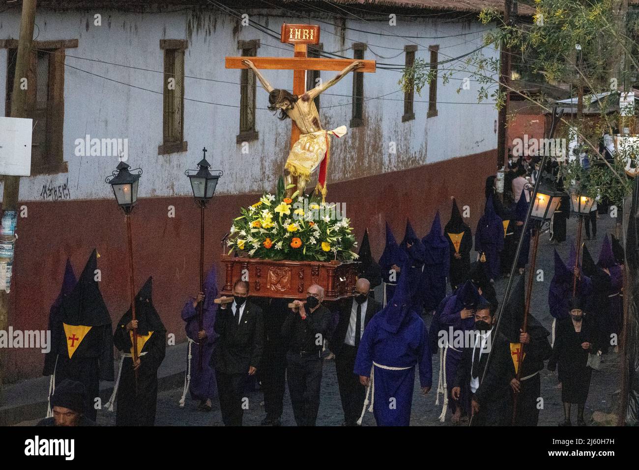 Roman Catholic hooded penitents wearing traditional capirotes, carry a ...