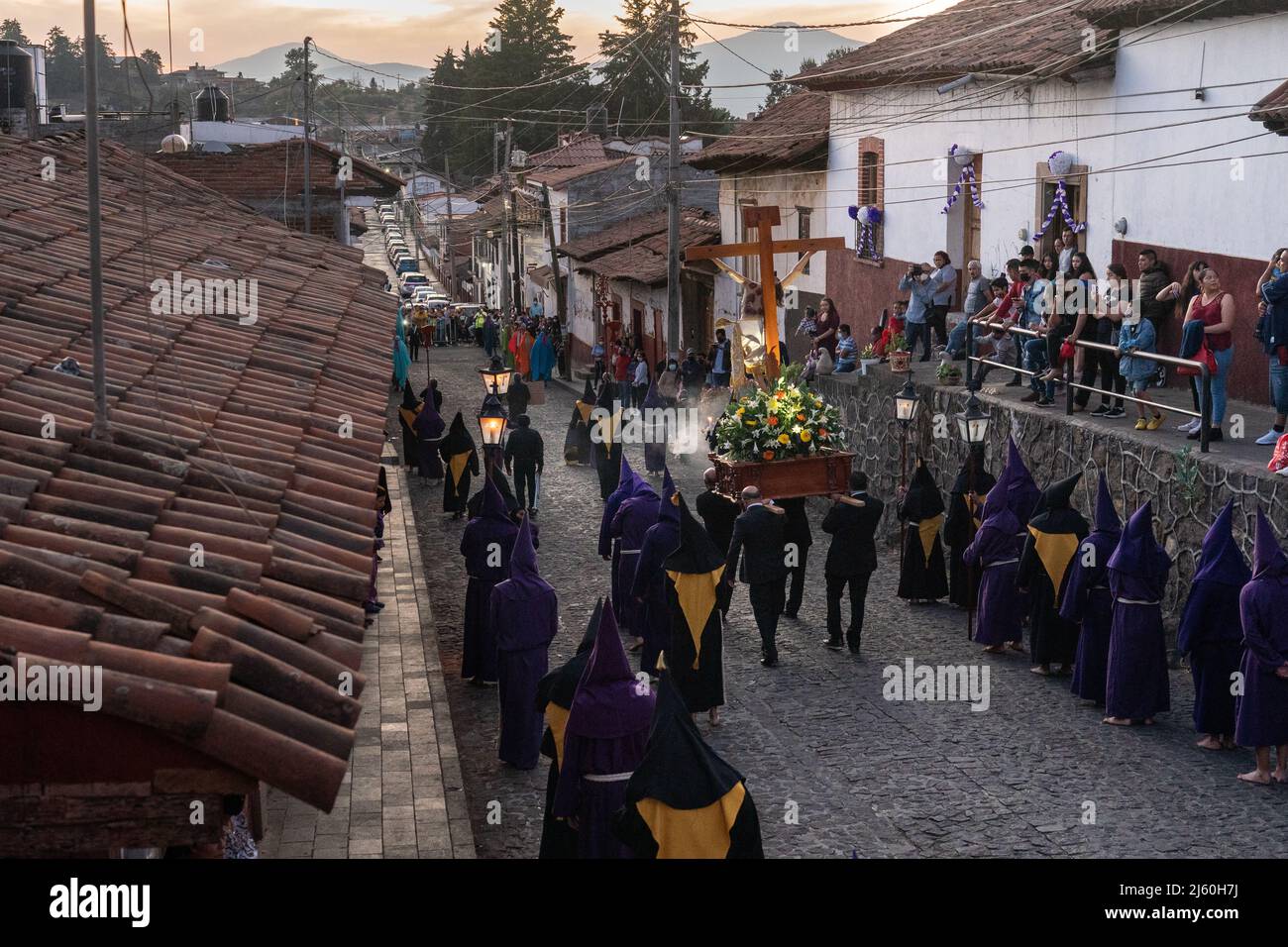 Roman Catholic hooded penitents wearing traditional capirotes, carry a ...