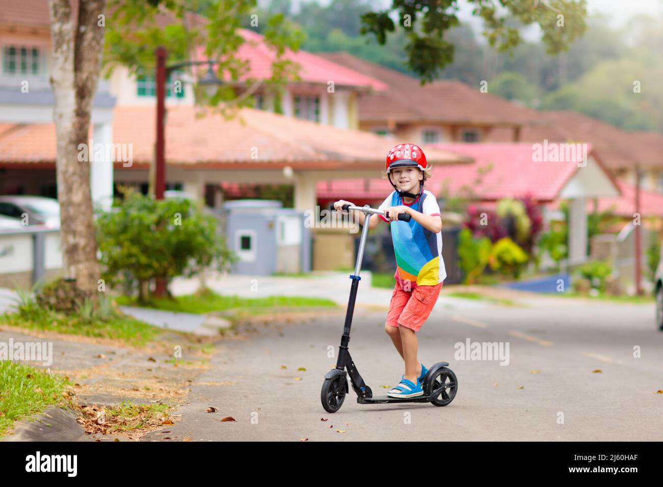 Little boy riding scooter. Kids ride kick board. Child playing on ...