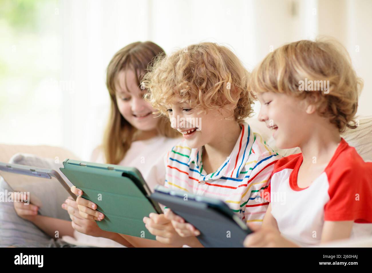 Kids with mobile phone. Child with tablet computer watching movie or ...