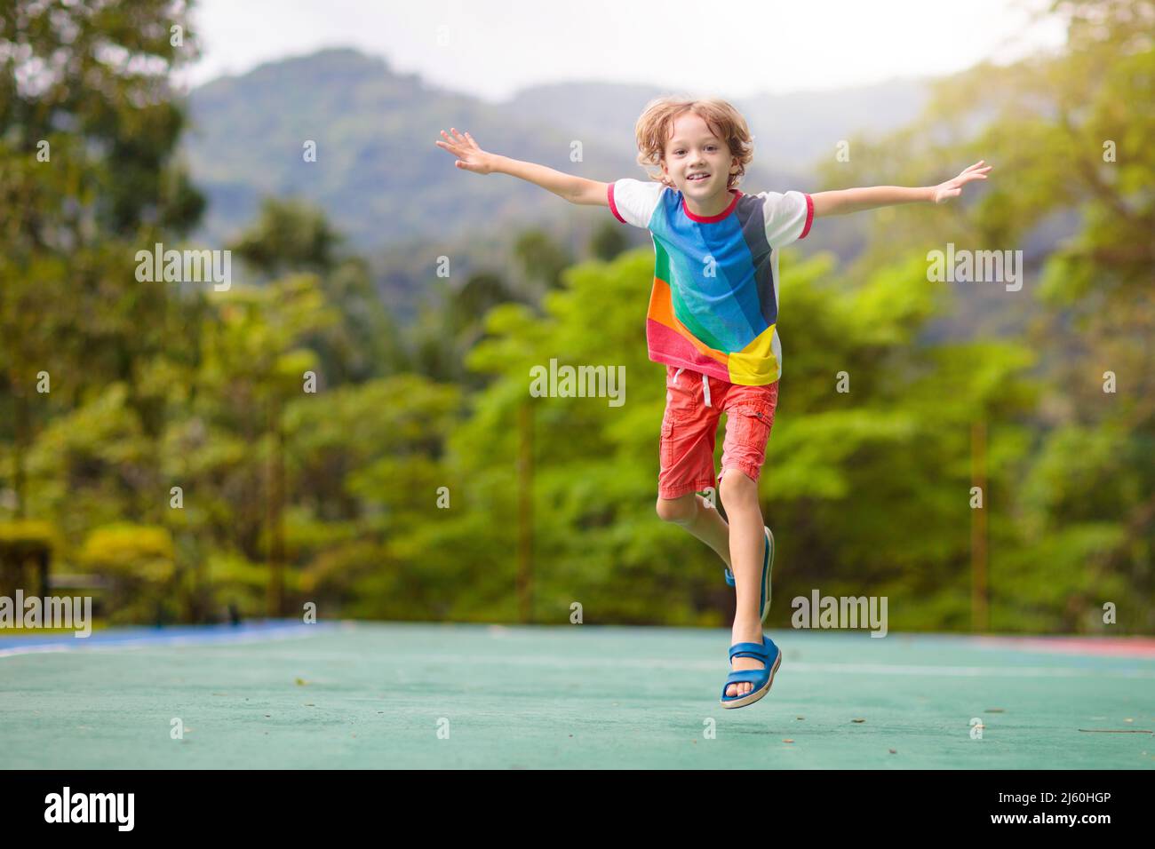 Child running in stadium. Kids run on outdoor school playground ...