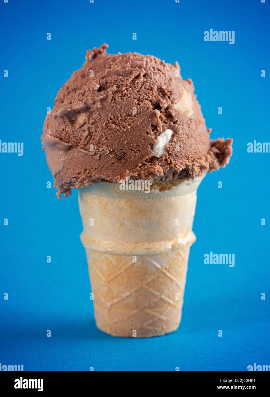A Mini Chocolate Rocky Road Ice Cream Cone on a Blue Background Stock ...