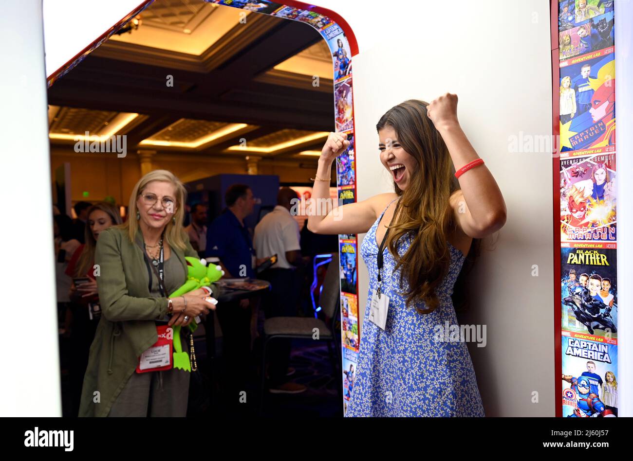 An attendee poses inside the Marvel Adventure Lab photo booth on the ...