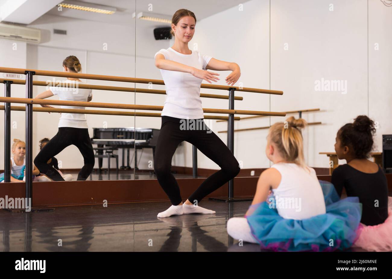 Dance teacher showing correct ballet position Stock Photo - Alamy