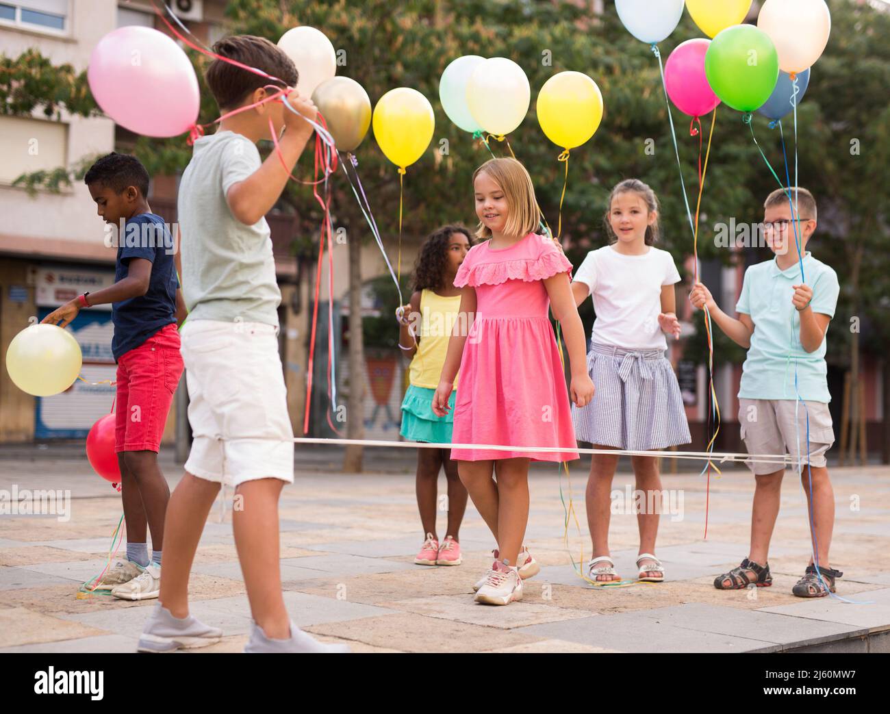 Children playing with balloons and jumping rope Stock Photo - Alamy