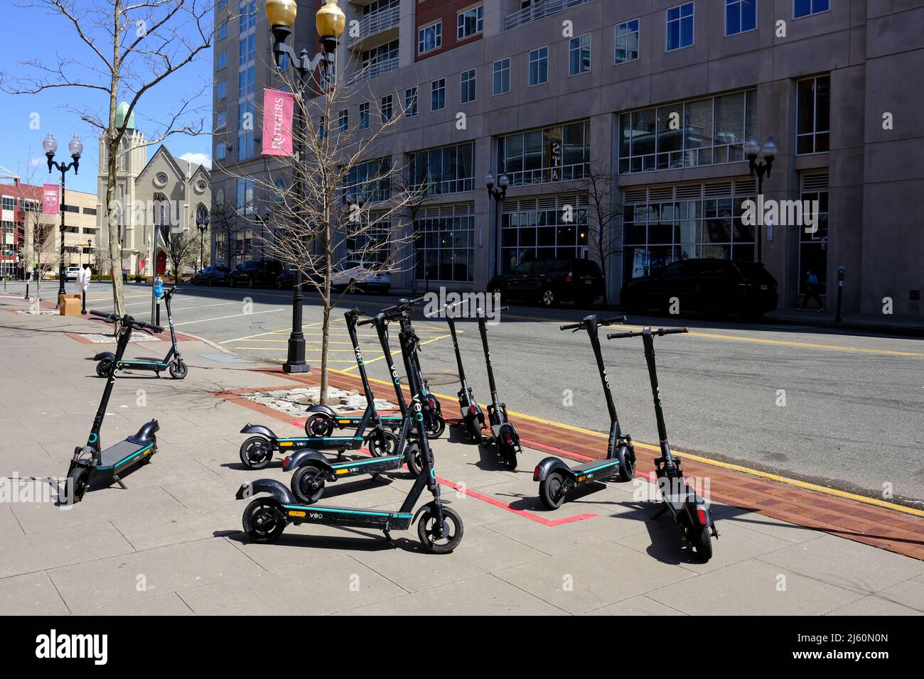 Rental scooters lined up on the street in New Brunswick, NJ Stock Photo ...