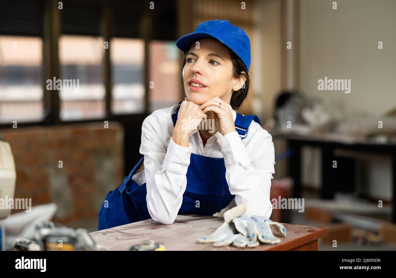 Confident female builder posing at construction site indoors Stock ...