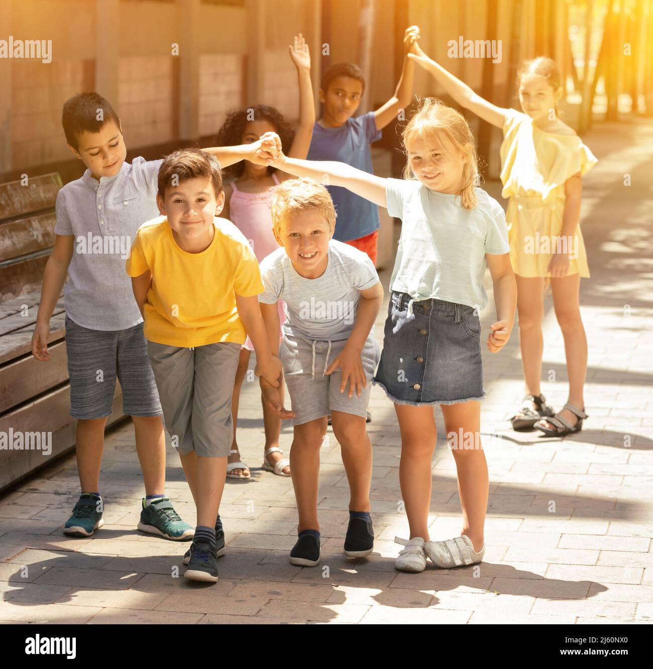 Group of happy kids playing a game called trickle on the street Stock ...