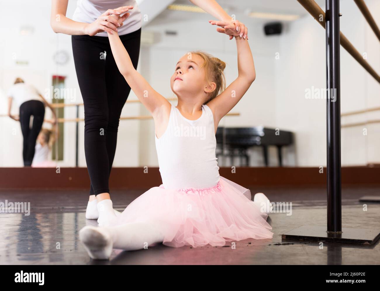 Little ballerina practicing front splits Stock Photo - Alamy