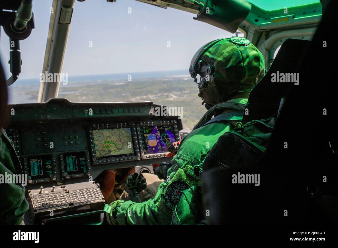 A U.S. Marine Corps pilot flies a UH-1Y Venom helicopter during a media ...