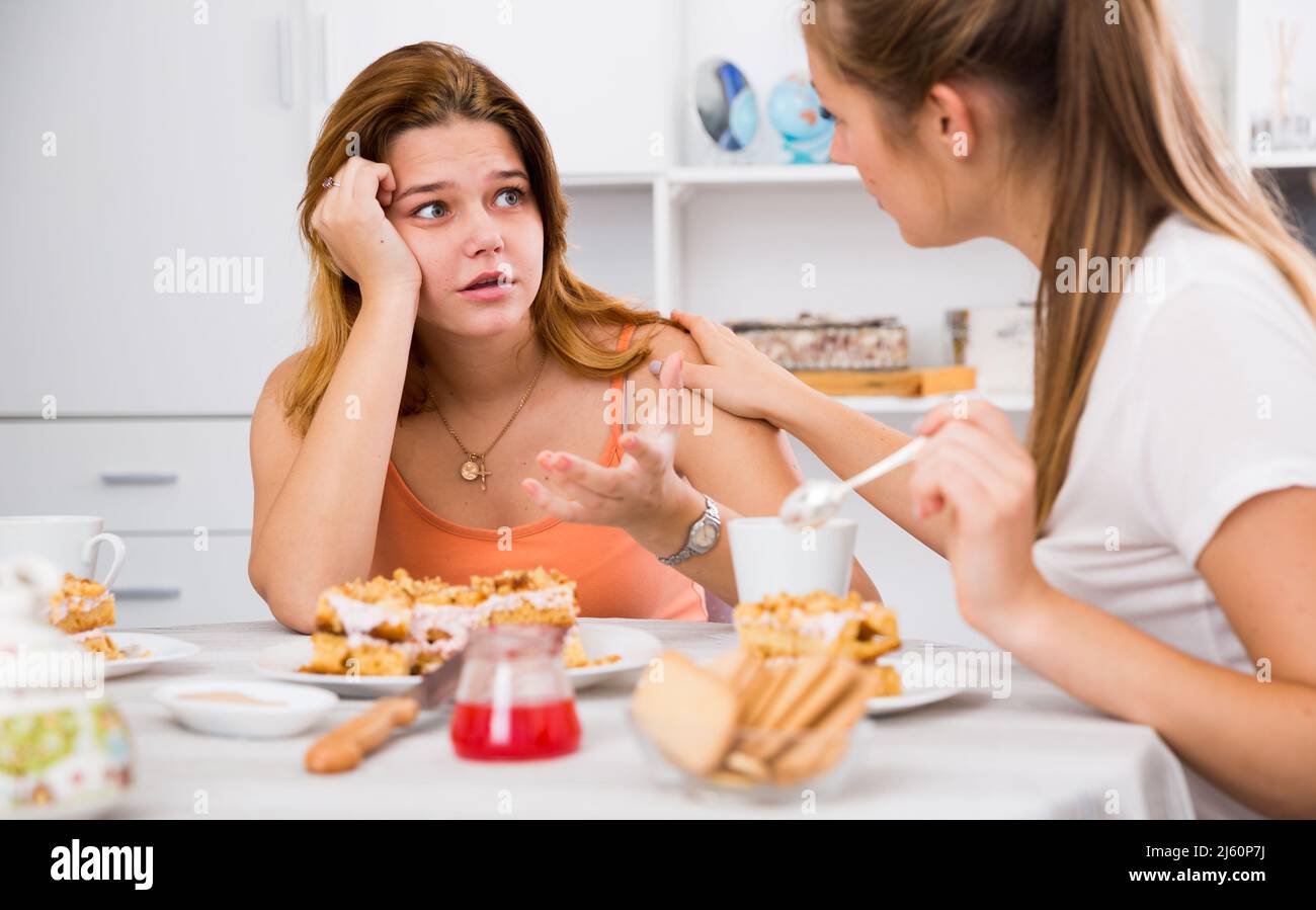 Portrait of female talking with sad girl friend Stock Photo - Alamy