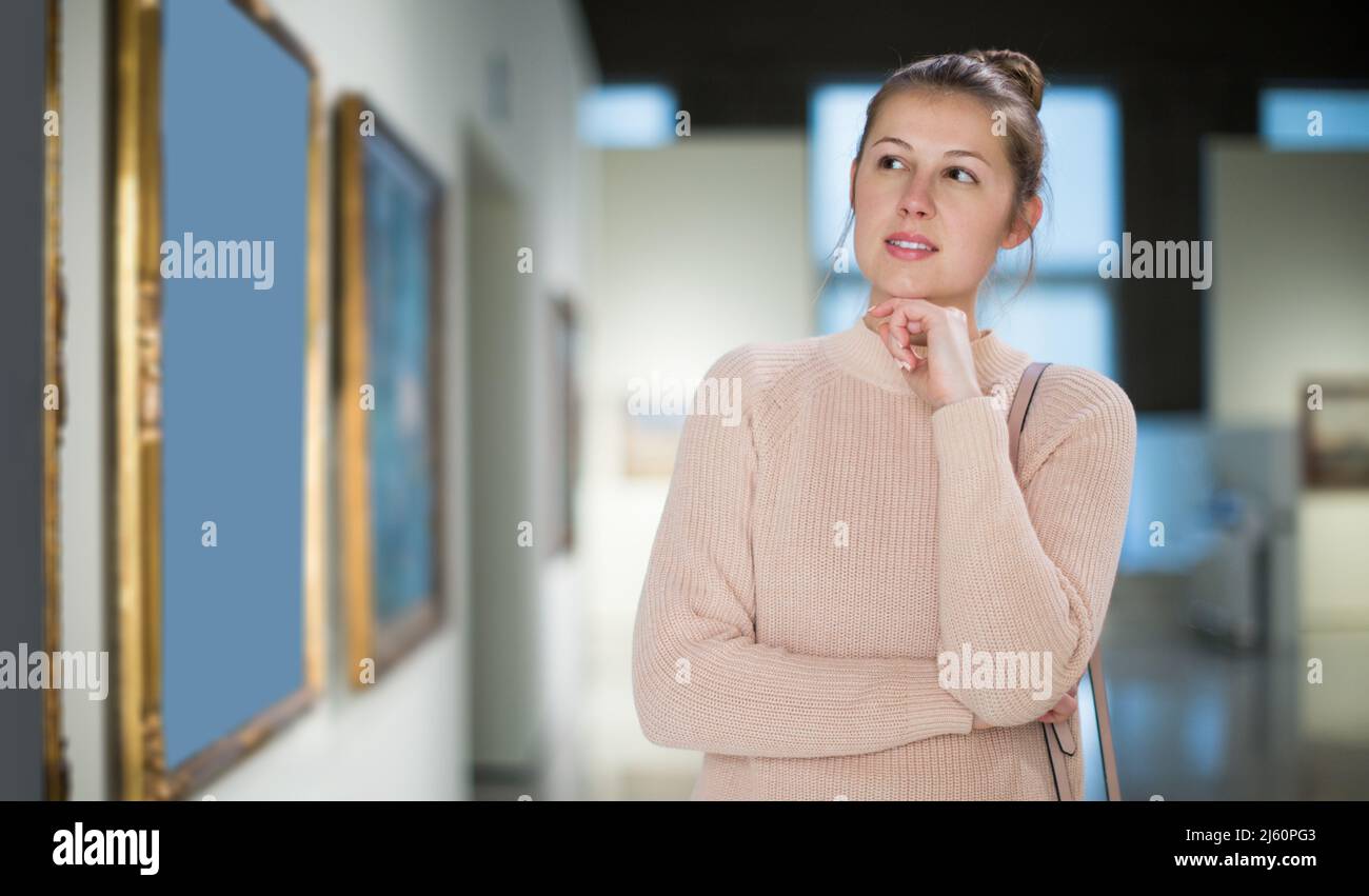 visitor in the art museum looking at picture Stock Photo - Alamy