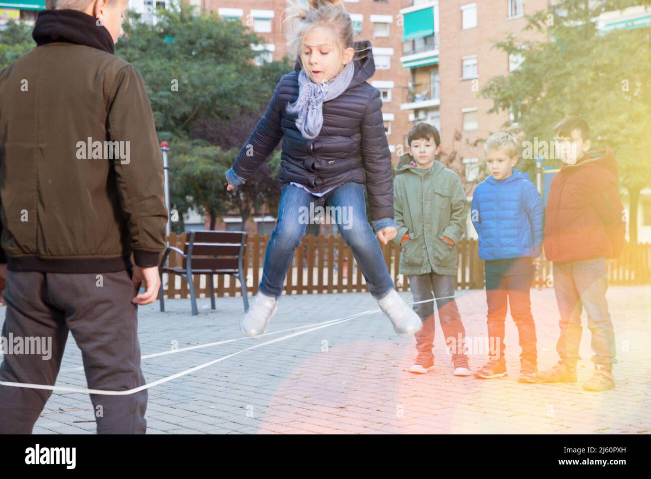 Kids playing chinese jump rope Stock Photo - Alamy