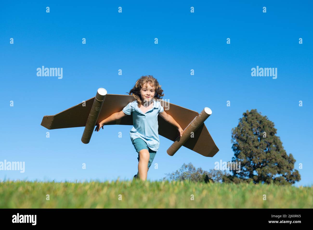 Boy child with wings at sky imagines a pilot and dreams of flying. Kids ...