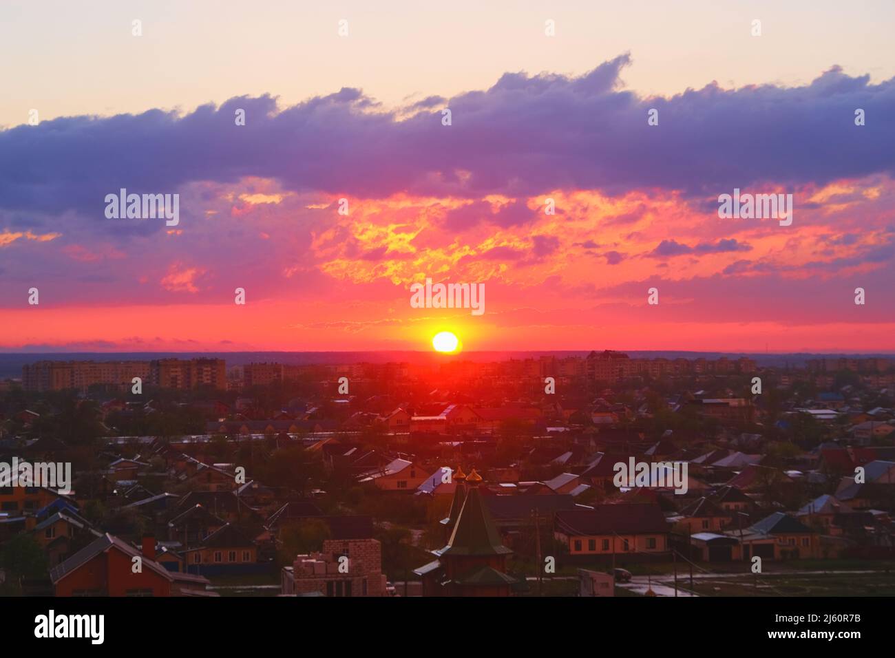 The sun is setting over the city. Rain at sunset Stock Photo - Alamy