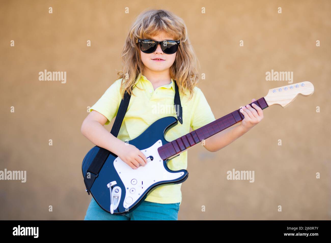 Child musician guitarist playing electric guitar. Music kids Stock ...