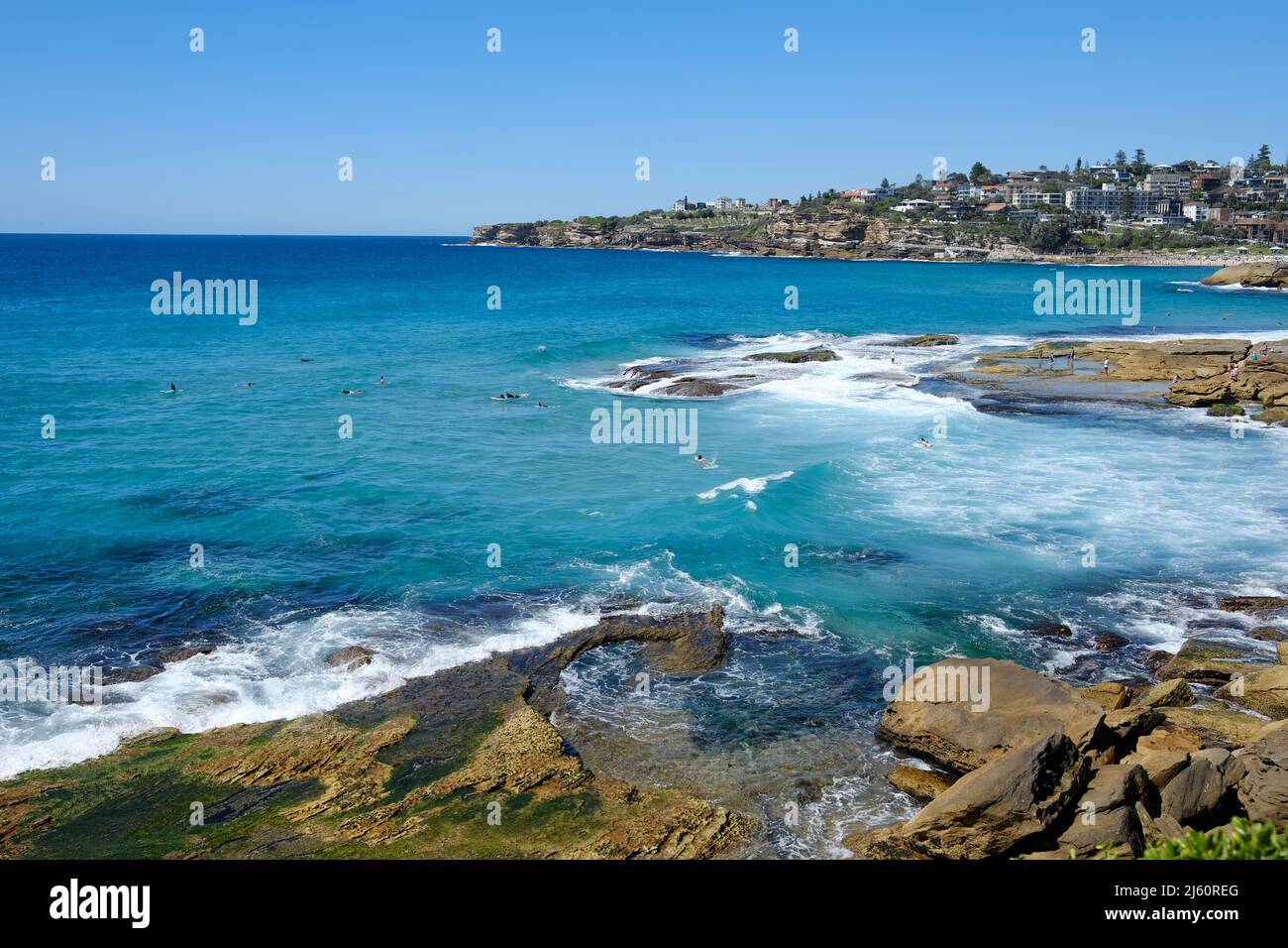Surfers riding the waves at Tamarama Beach, on the eastern coast of ...