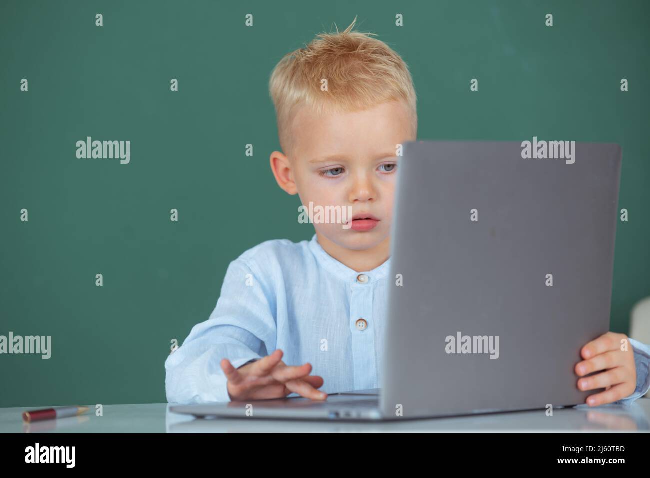 Serious concentrate kid boy learning lesson at school, making homework ...