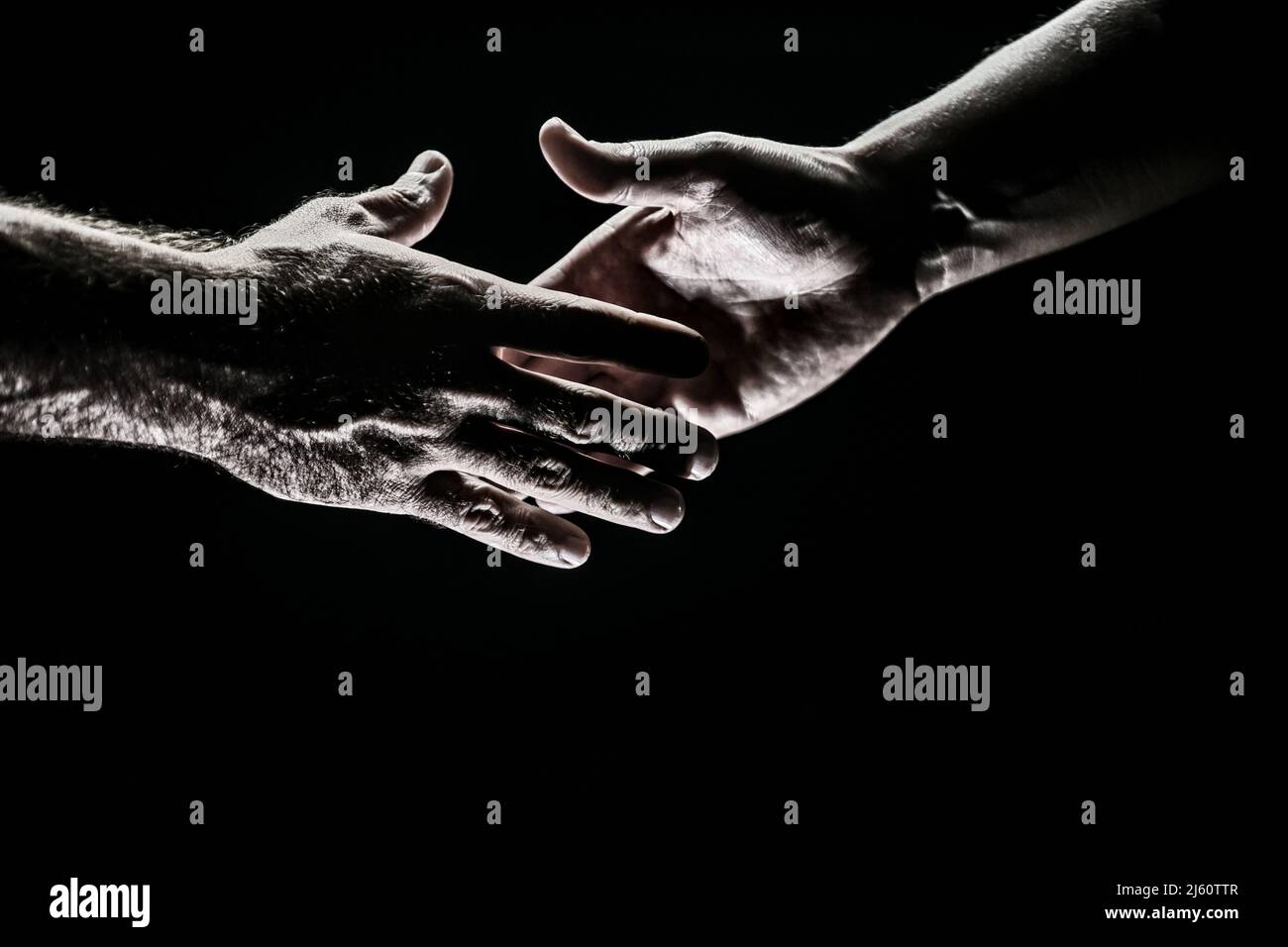 Handshake. Men holding hands isolated on black. Connection and human ...