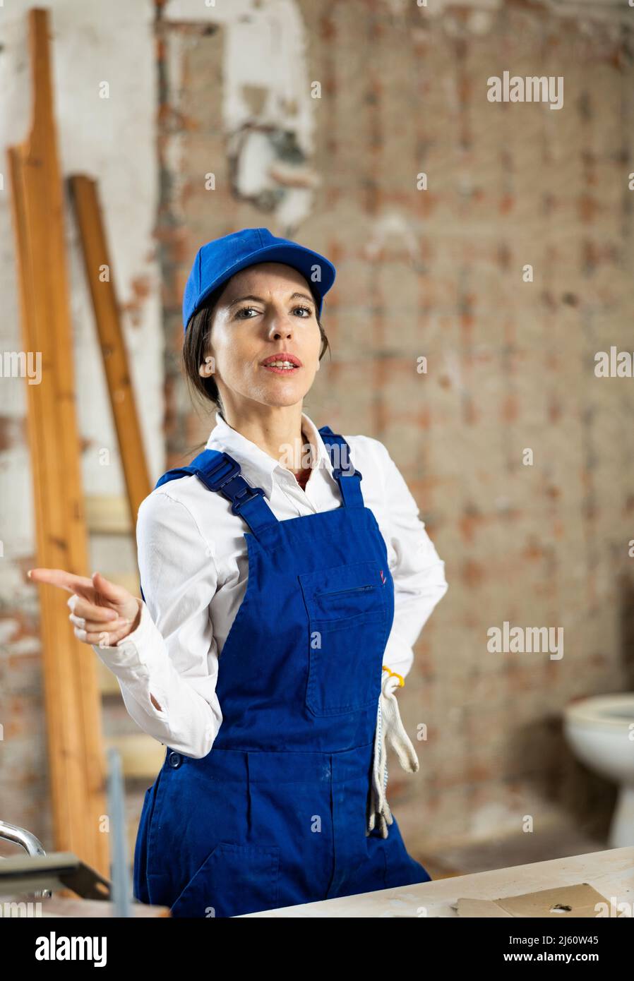 Female foreman standing inside building under construction Stock Photo ...