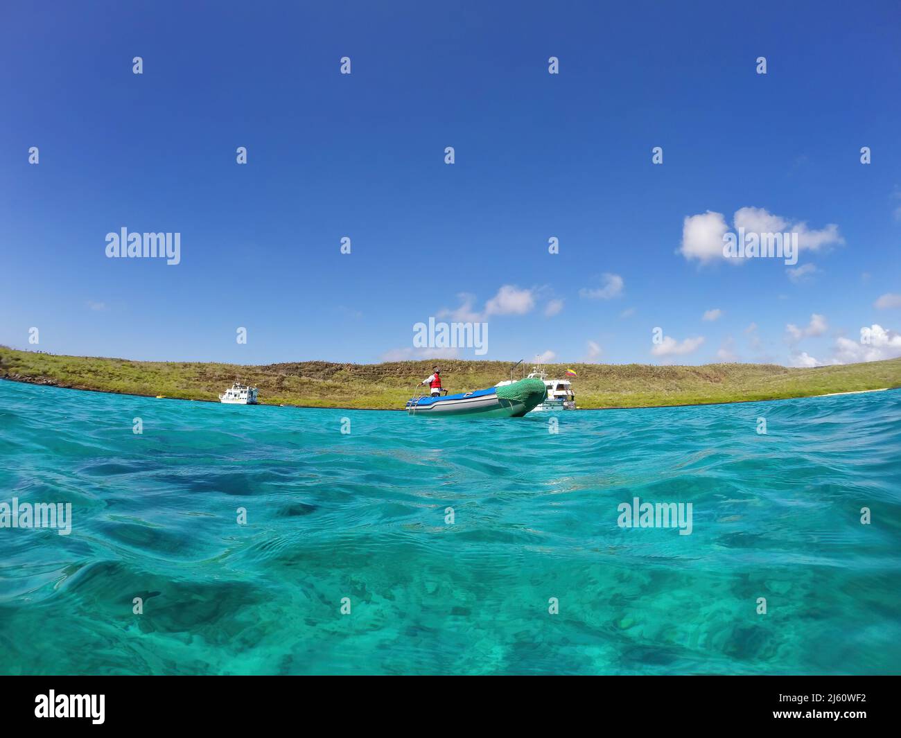 Tourist boats anchored near Santa Fe Island, Galapagos National Park ...