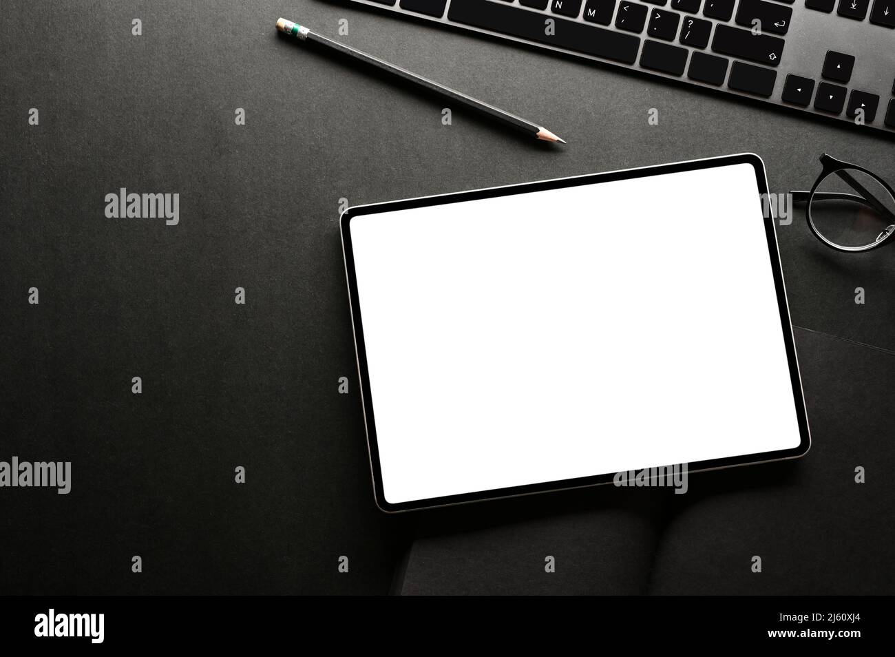 Top view, Dark black office desk workspace with pc keyboard, pencil ...