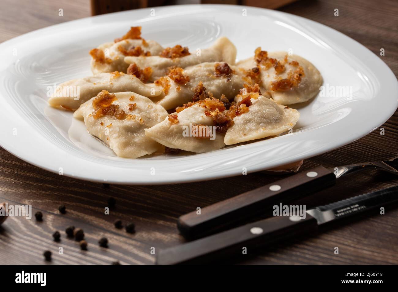 Traditional ukrainian dish vareniki served in a bowl with sour cream ...