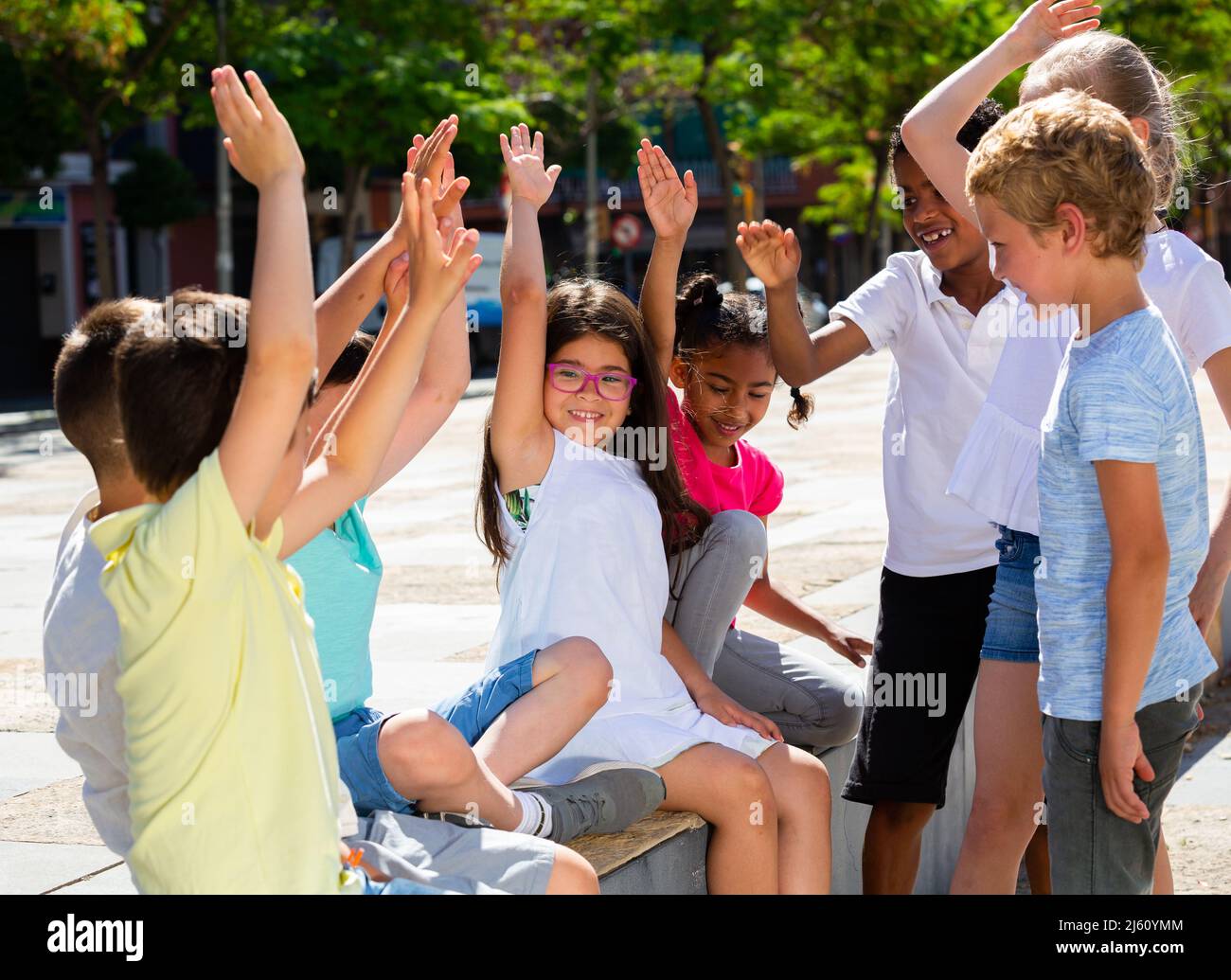 Happy kids playing on summer city street Stock Photo - Alamy