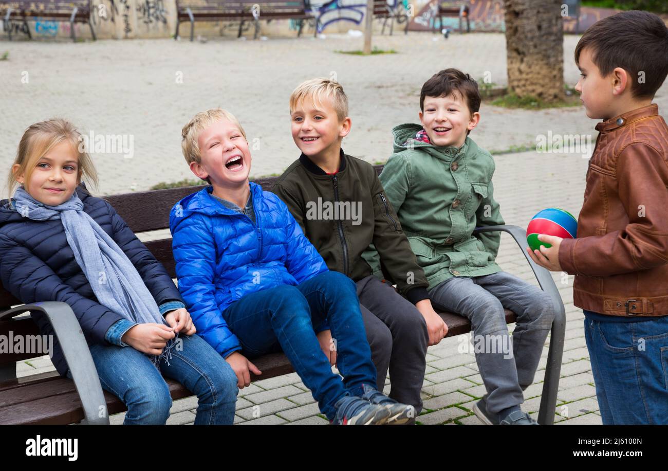 Kids playing ball together on the street Stock Photo - Alamy