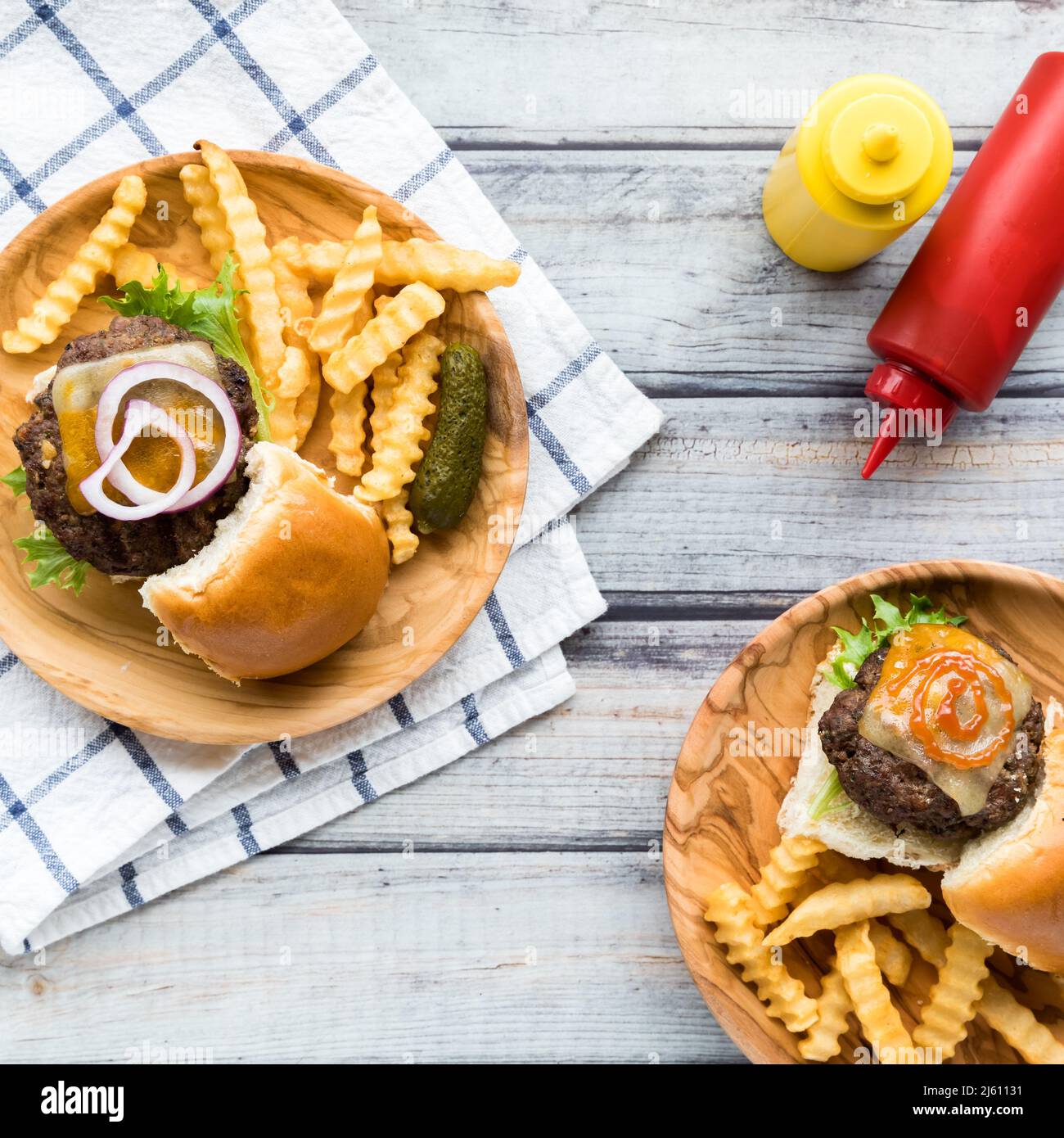 Top down view of barbecue cheeseburger sliders served with french fries ...