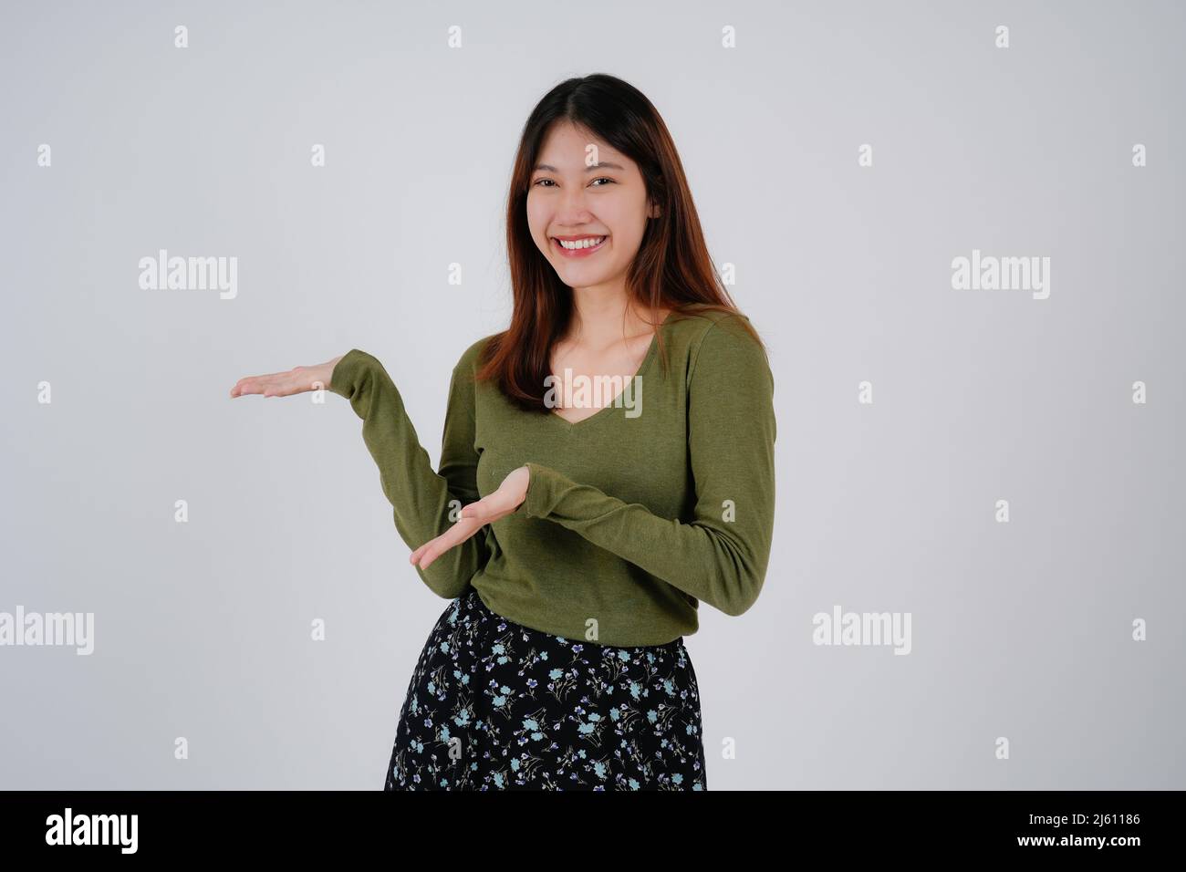 Young asian woman standing over isolated white background happy face ...
