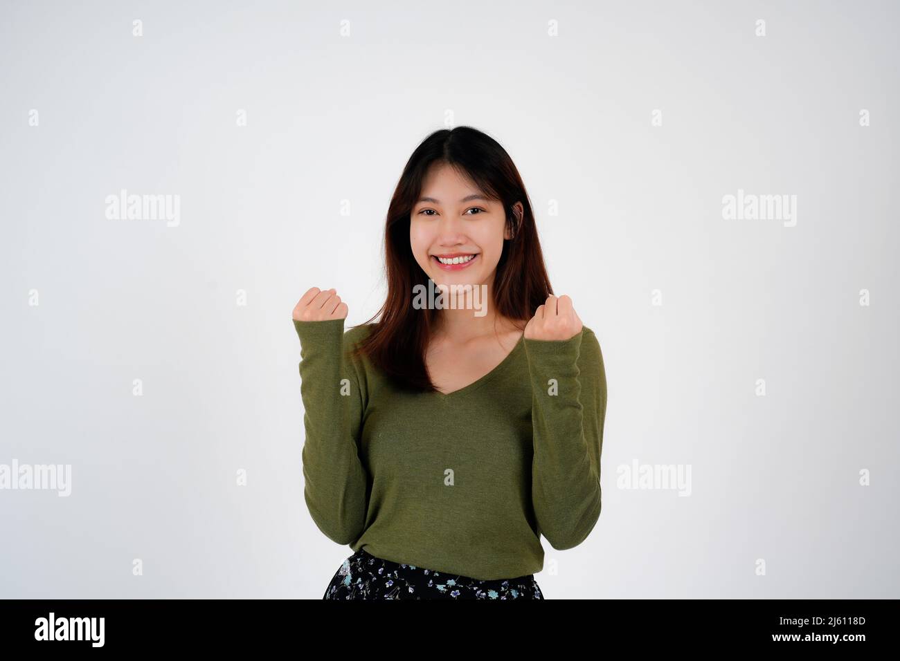 Young asian woman standing over isolated white background happy face ...