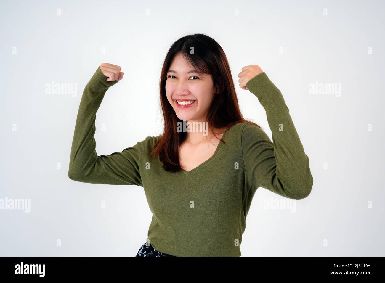 Young asian woman standing over isolated white background happy face ...